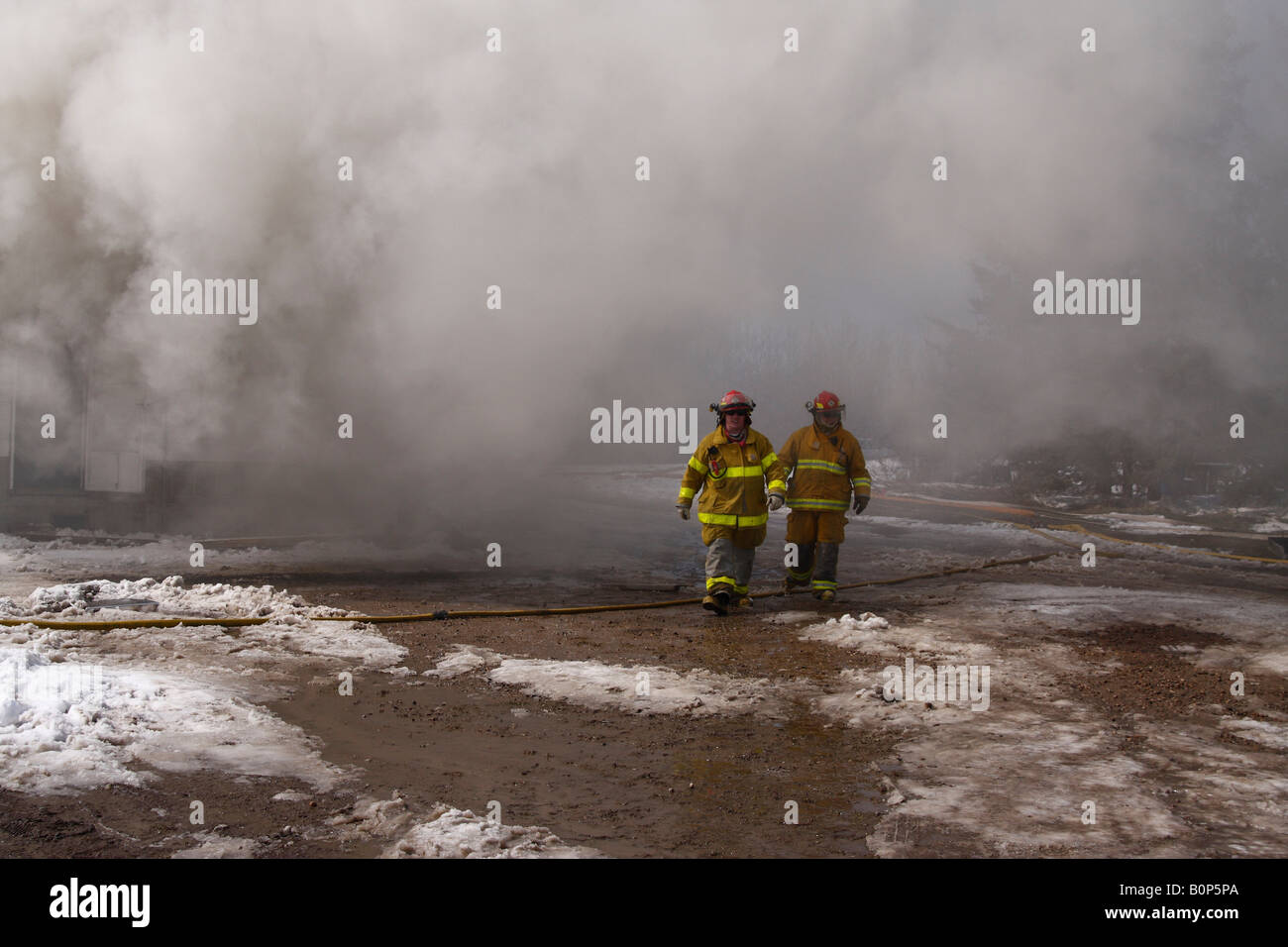 Two firefighters move to rest Stock Photo - Alamy