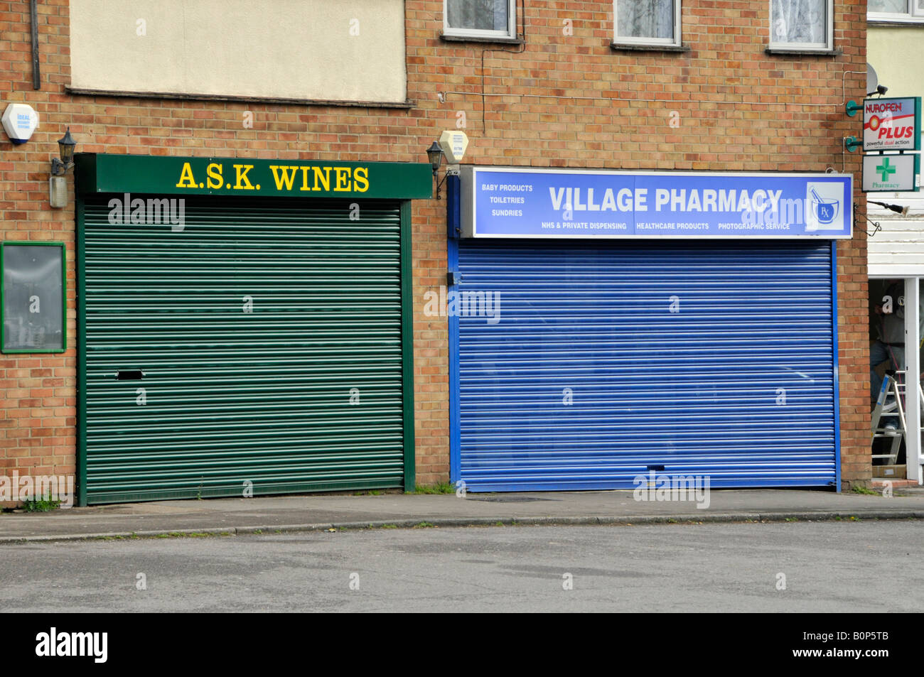 Roller shutter security covers in use on wine store and pharmacy in ...