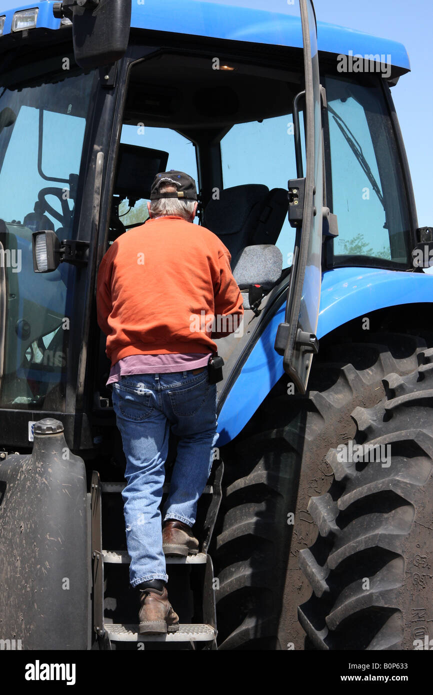 Farmer entering Tractor Cab Stock Photo - Alamy