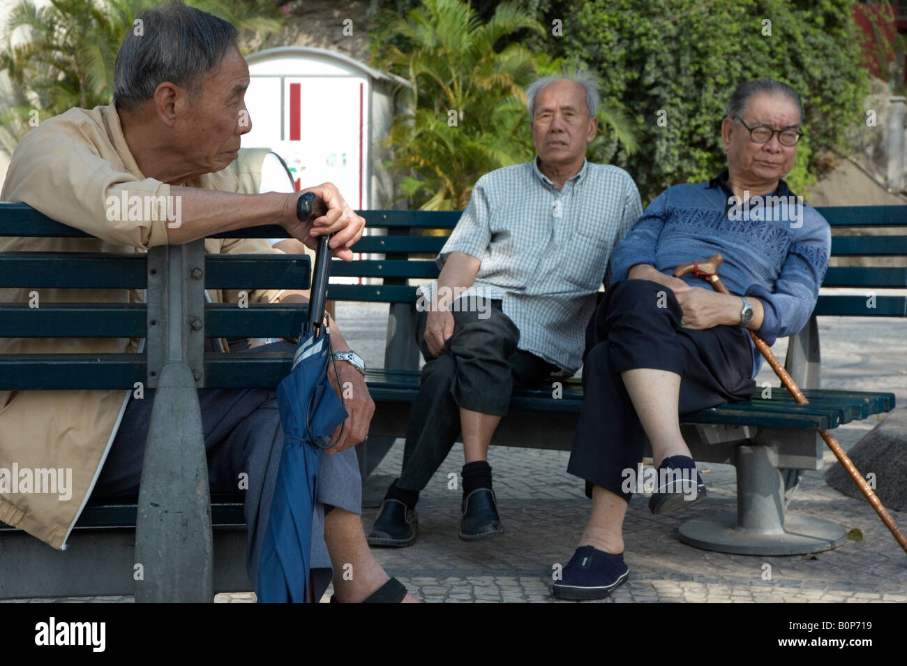 Local men sit in a park, Macau, China Stock Photo - Alamy