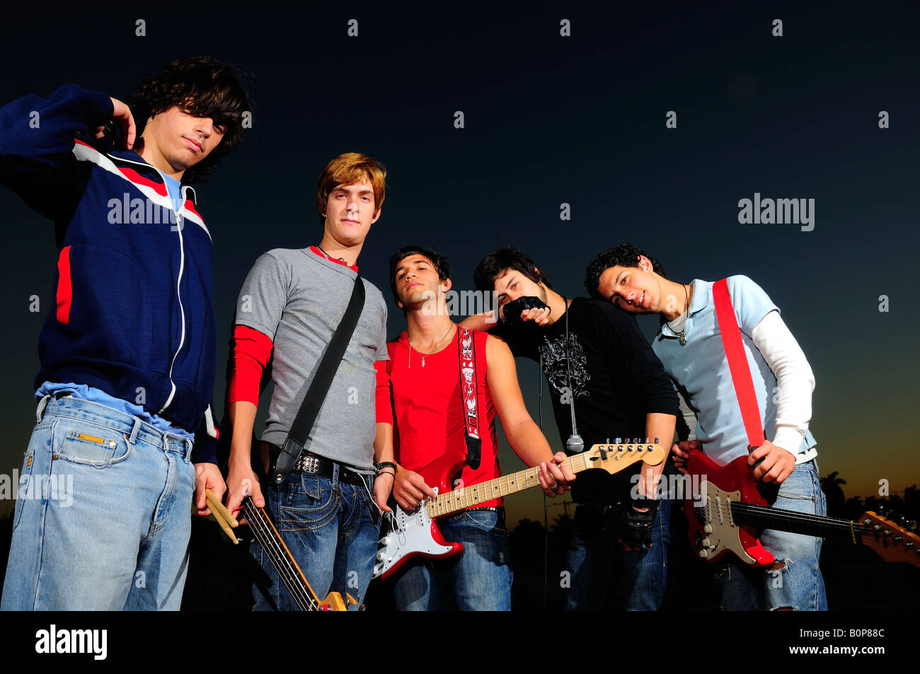 Casual group of young musicians posing with instruments Stock Photo - Alamy