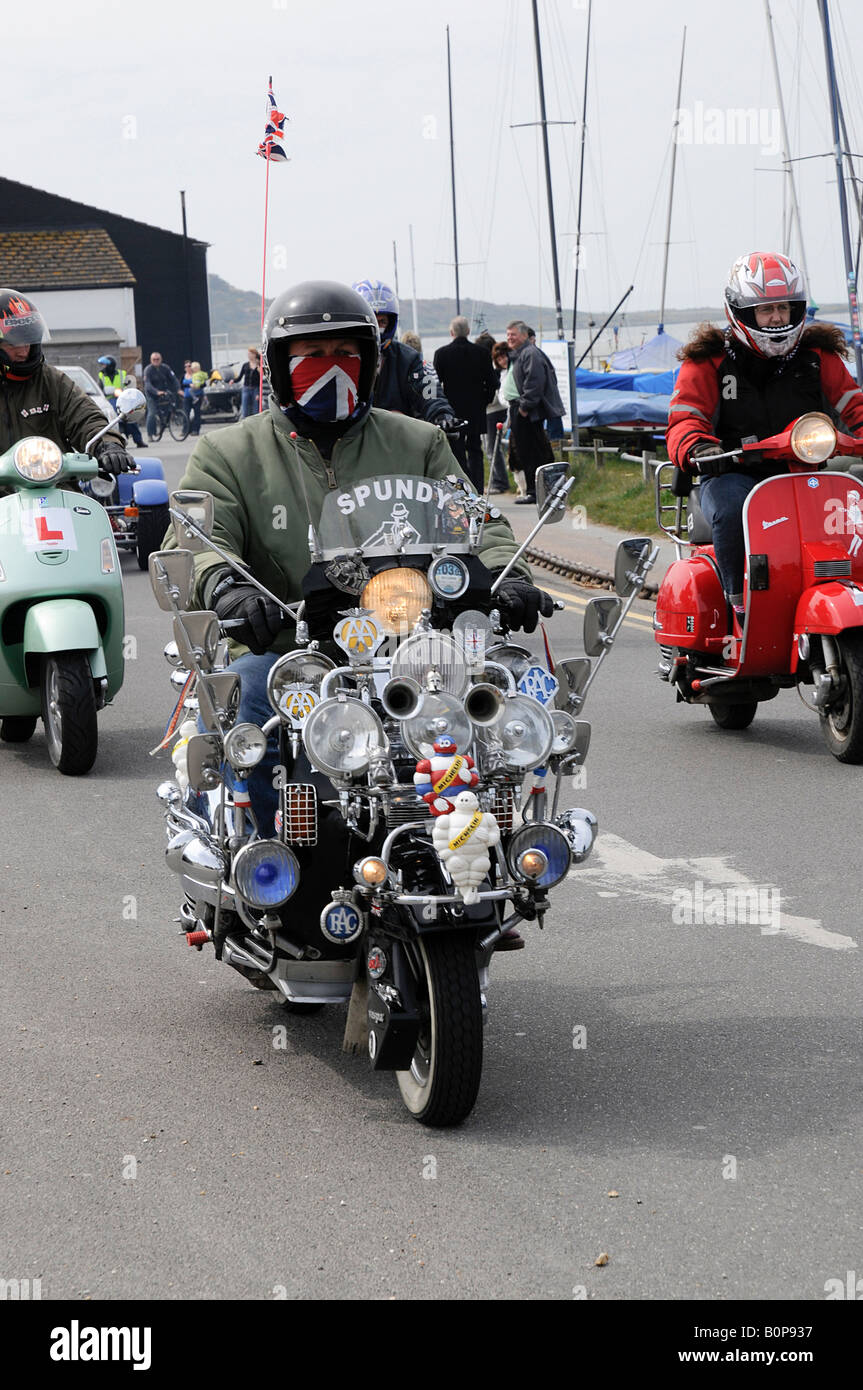 Scooterist riding past Mudeford Quay Stock Photo - Alamy