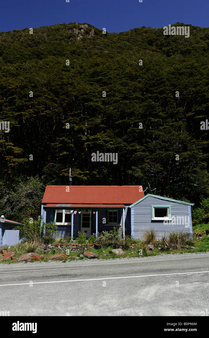 An old grey shack with orange roof in set against a mountain in Arthurs ...
