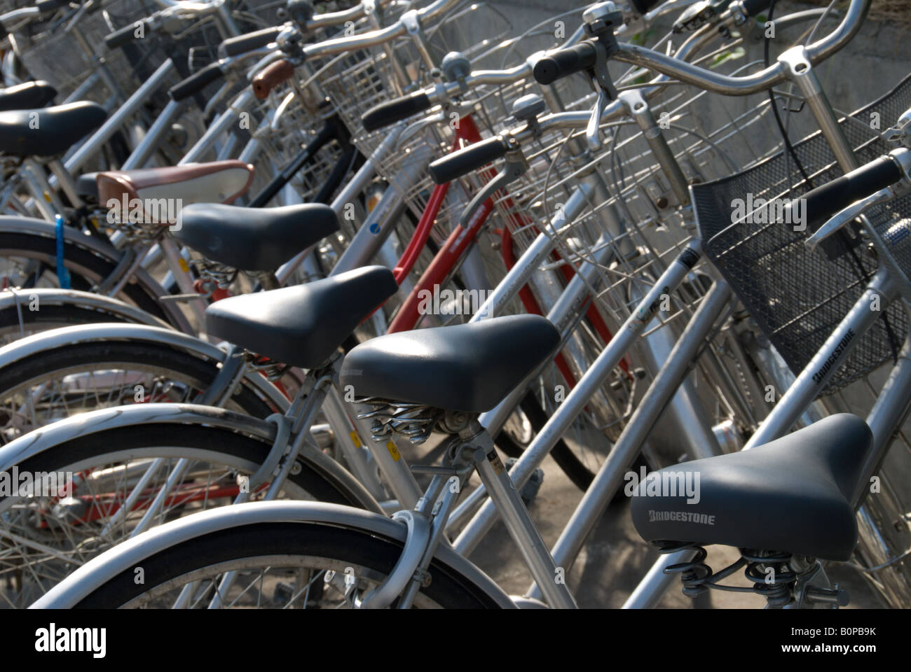 Commuter bikes parked in a bicycle parking area outside Shimosuwa ...