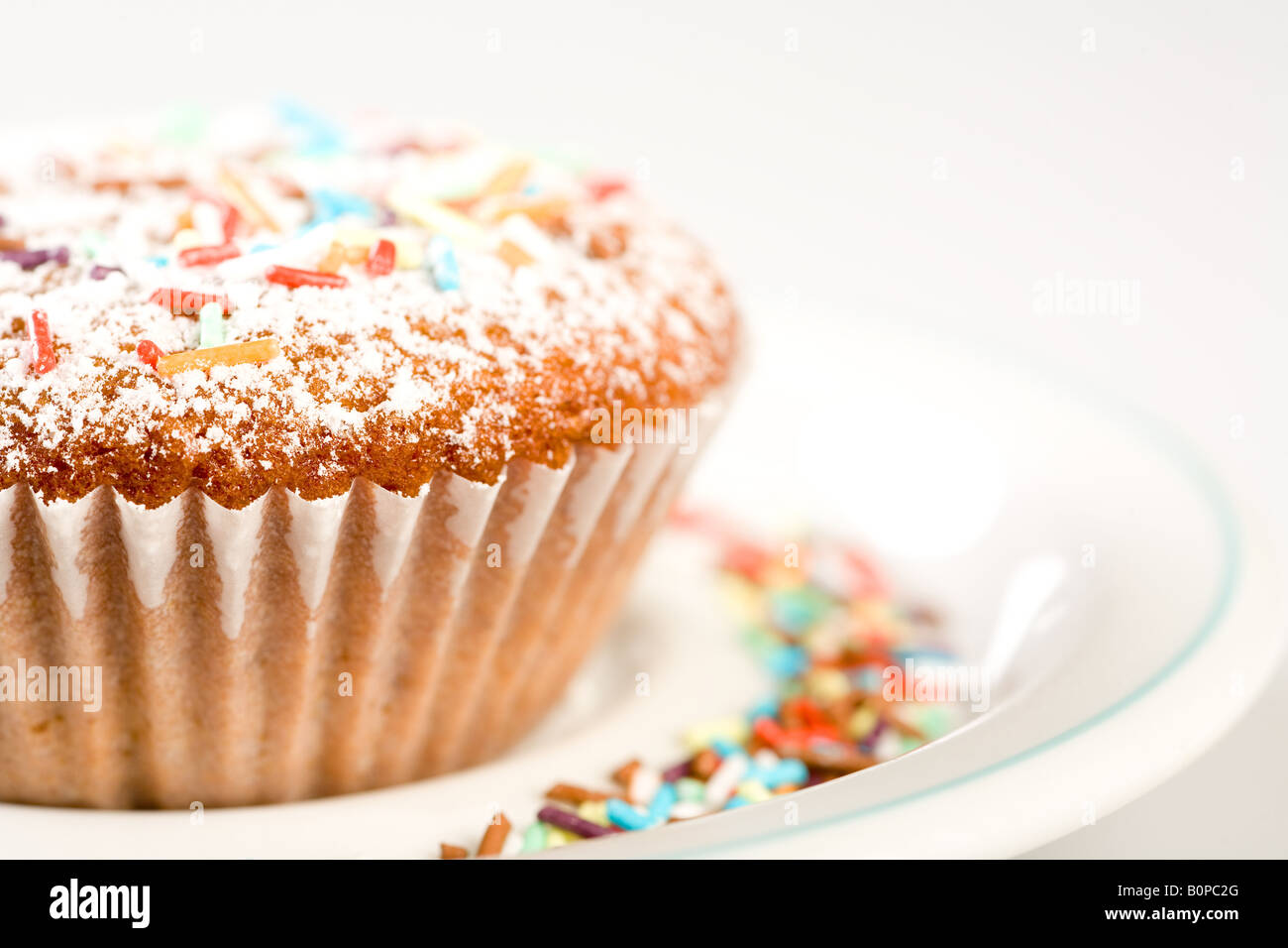 tasty muffin with colorful sprinkles isolated Stock Photo - Alamy