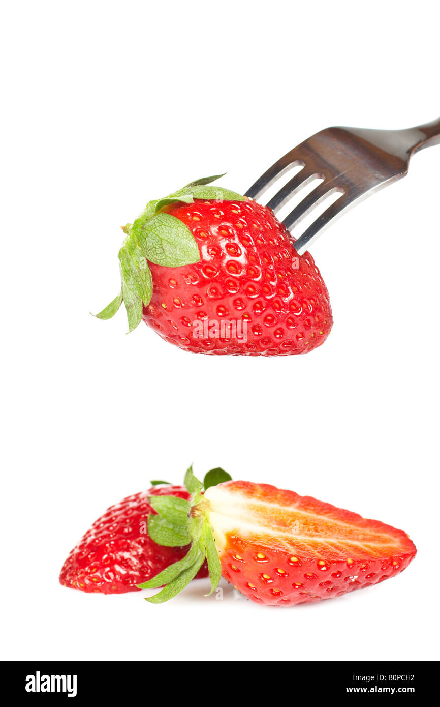 The fork pricking the strawberry isolated on white background Shallow ...