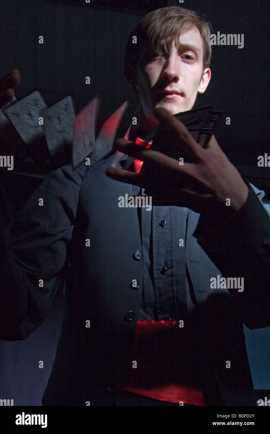 young magician doing a card trick Stock Photo - Alamy