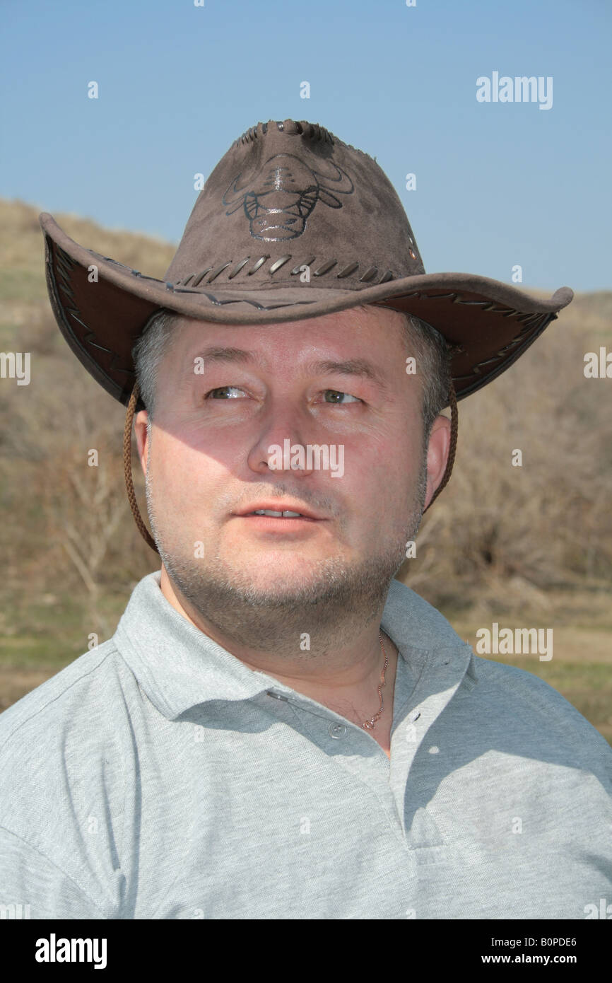 Man with cowboy hat looking and thinking Stock Photo - Alamy