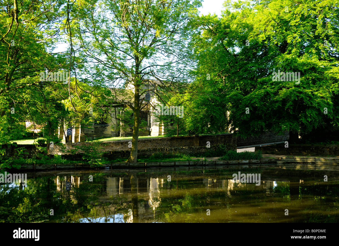 Birstall dam with the Parish Church beyond Stock Photo - Alamy