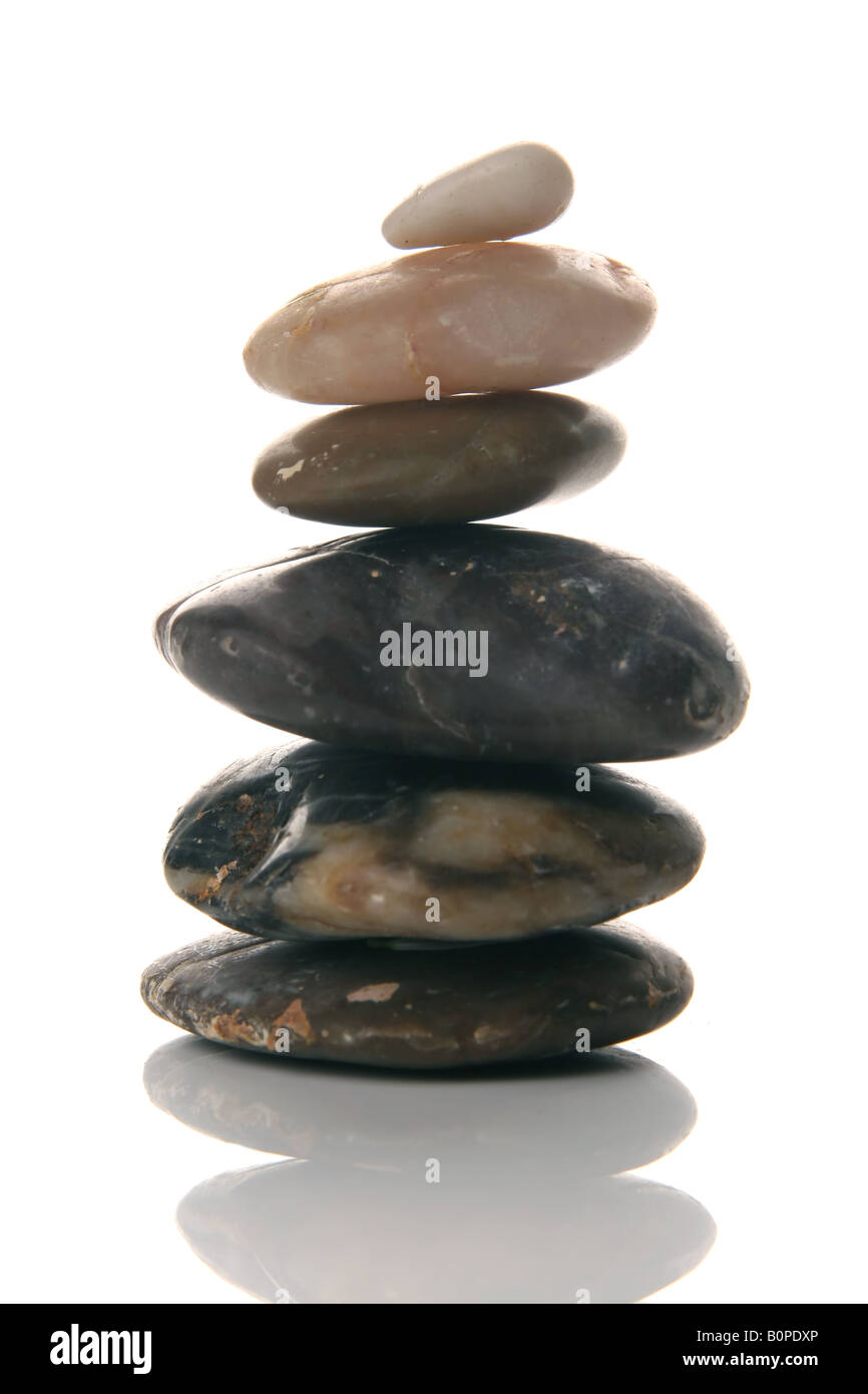 Pebbles balancing on white Stock Photo - Alamy