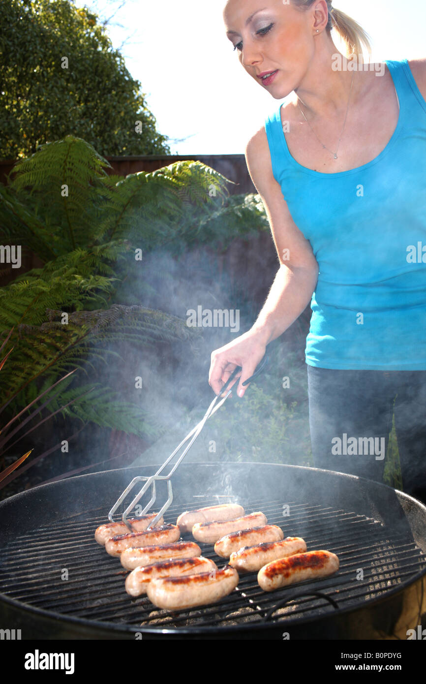 Young Woman Cooking Sausages Model Released Stock Photo - Alamy