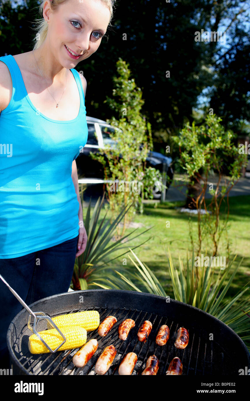 Woman Cooking on BBQ Model Released Stock Photo - Alamy