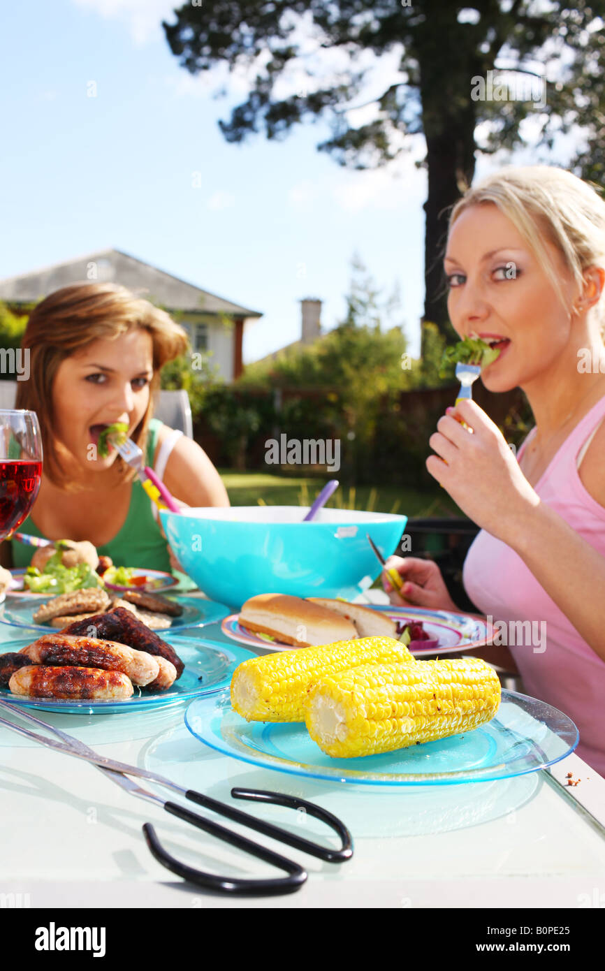 Young Women Eating at a Barbecue Model Released Stock Photo - Alamy