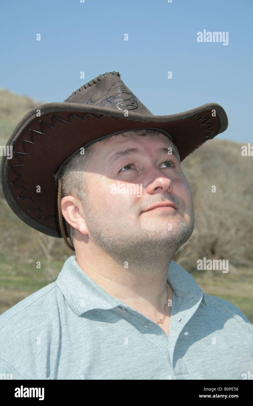 Man with cowboy hat looking and thinking Stock Photo - Alamy