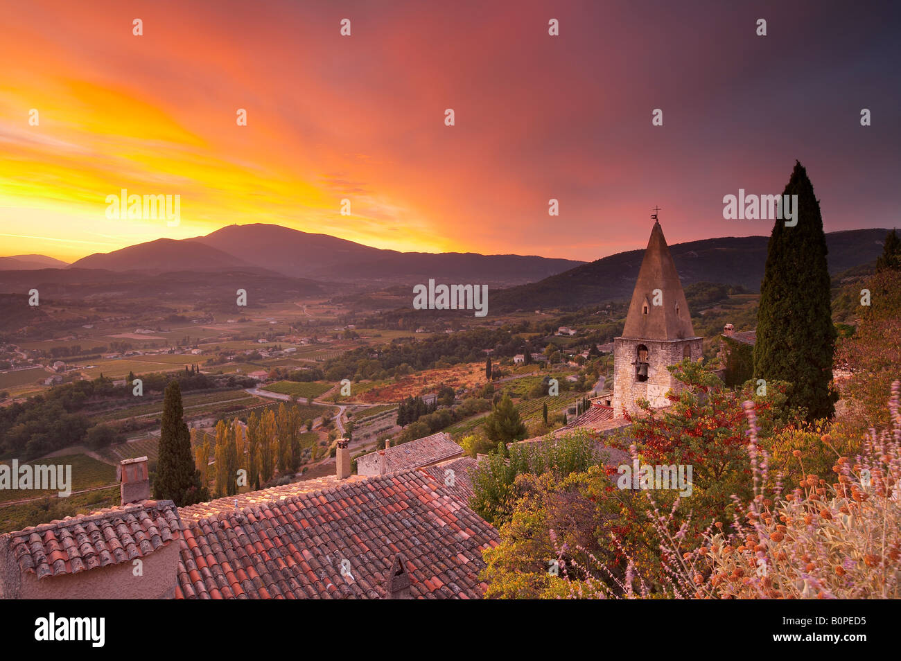 dawn over Mount Ventoux from the village of Crestet in the Dentelles de ...