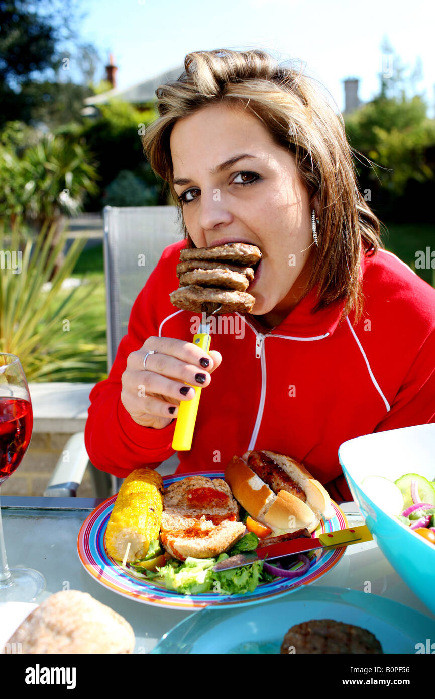 Young Woman Eating Burger Model Released Stock Photo - Alamy