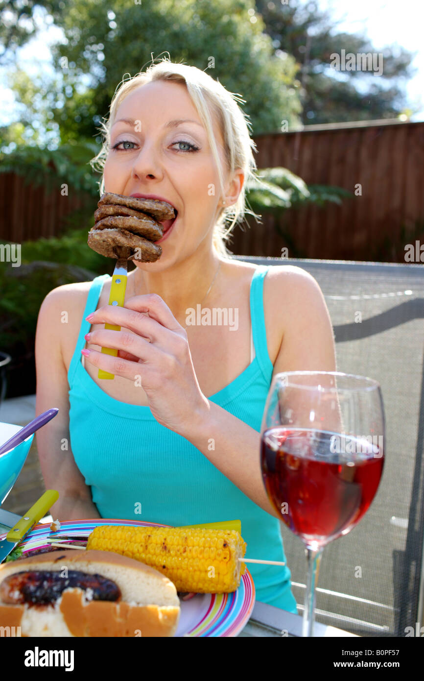 Young Woman Eating Burger Model Released Stock Photo - Alamy