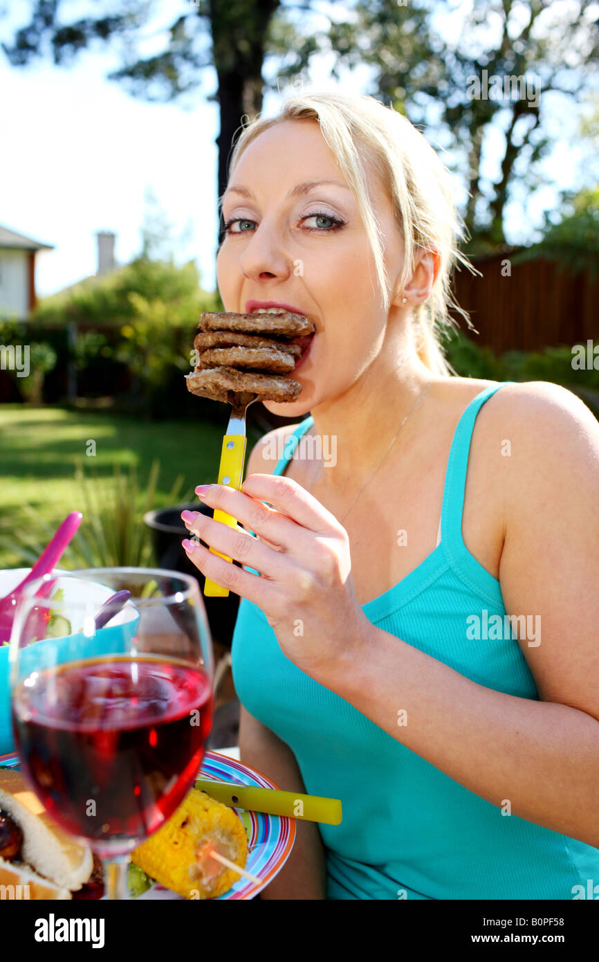 Young Woman Eating Burger Model Released Stock Photo - Alamy