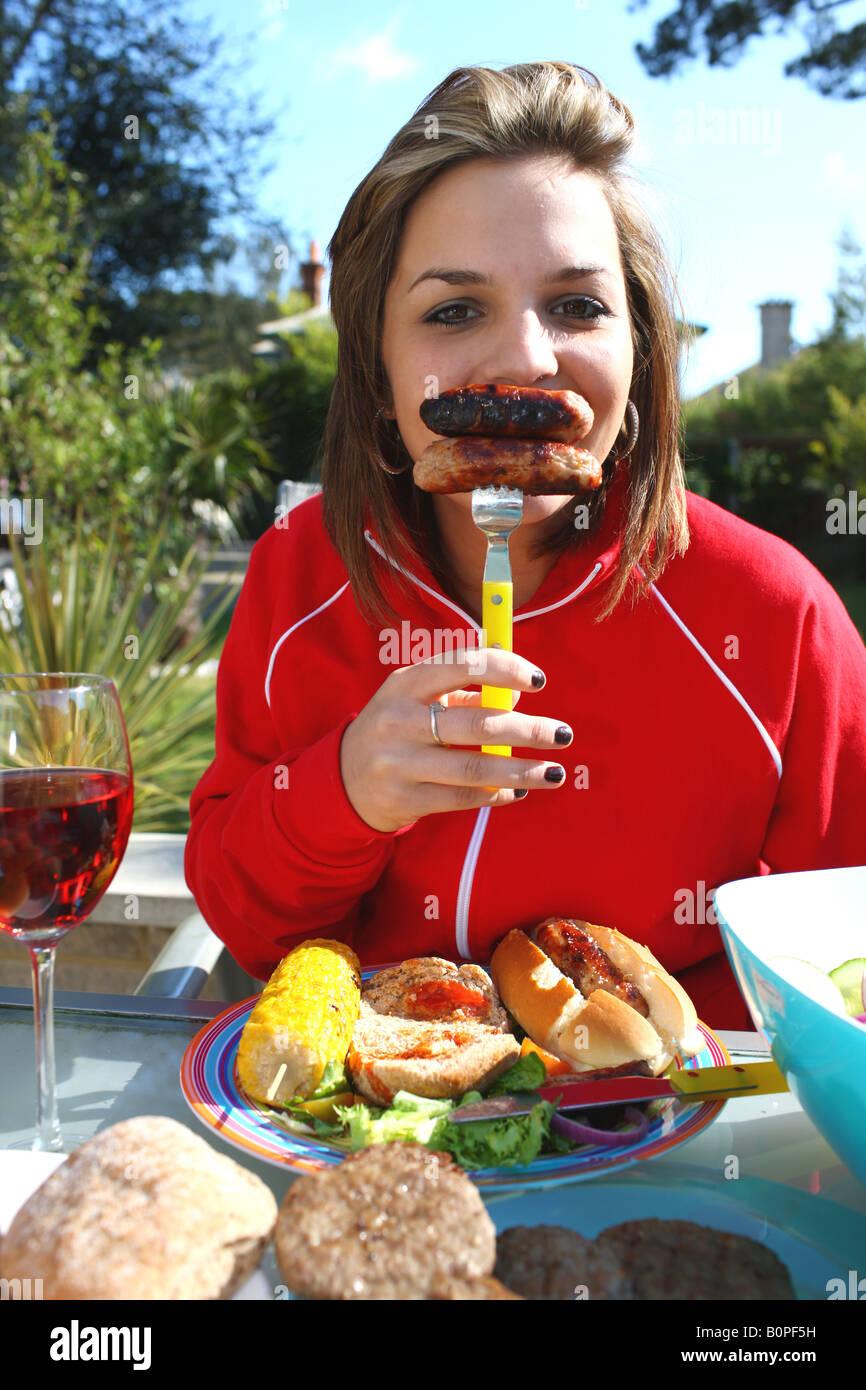 Young Woman Eating Sausages Model Released Stock Photo - Alamy