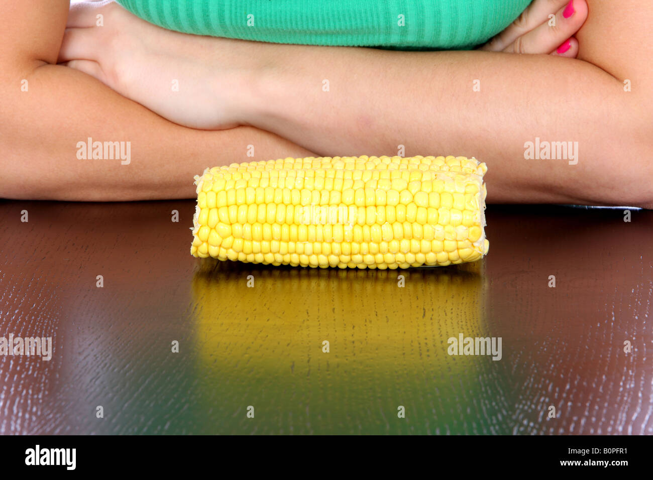 Young Woman Holding And Eating A Fresh Ripe Healthy Corn On The Cob ...