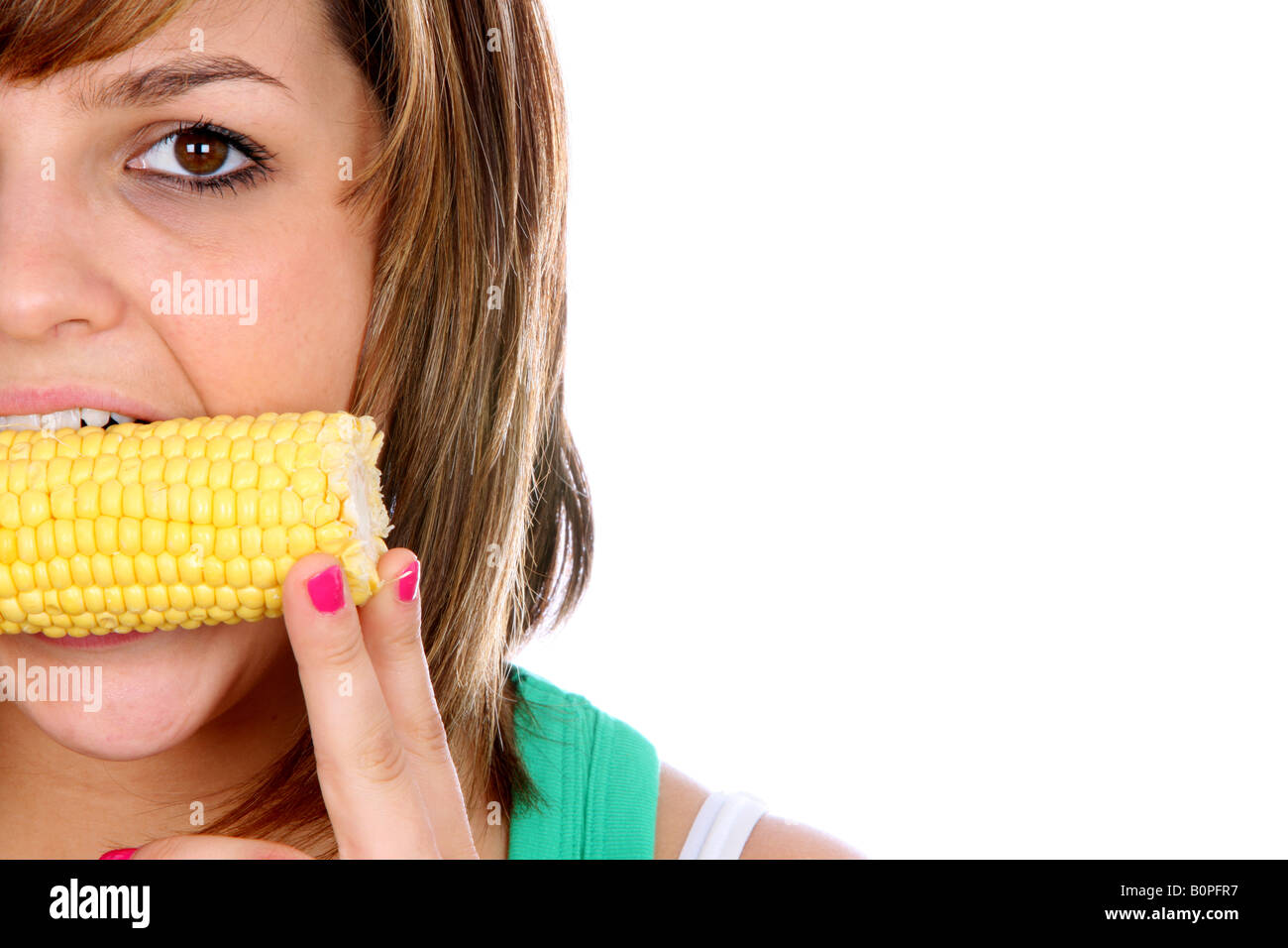 Young Woman Holding And Eating A Fresh Ripe Healthy Corn On The Cob ...