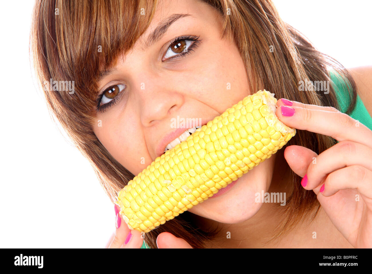 Young Woman Holding And Eating A Fresh Ripe Healthy Corn On The Cob ...
