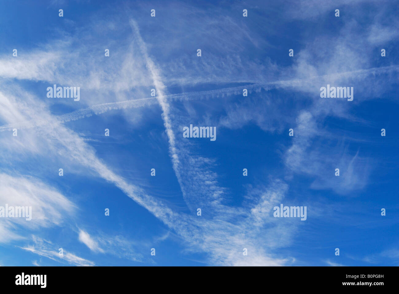vapor trails or chemtrails from jets in sky often forming grid or ...