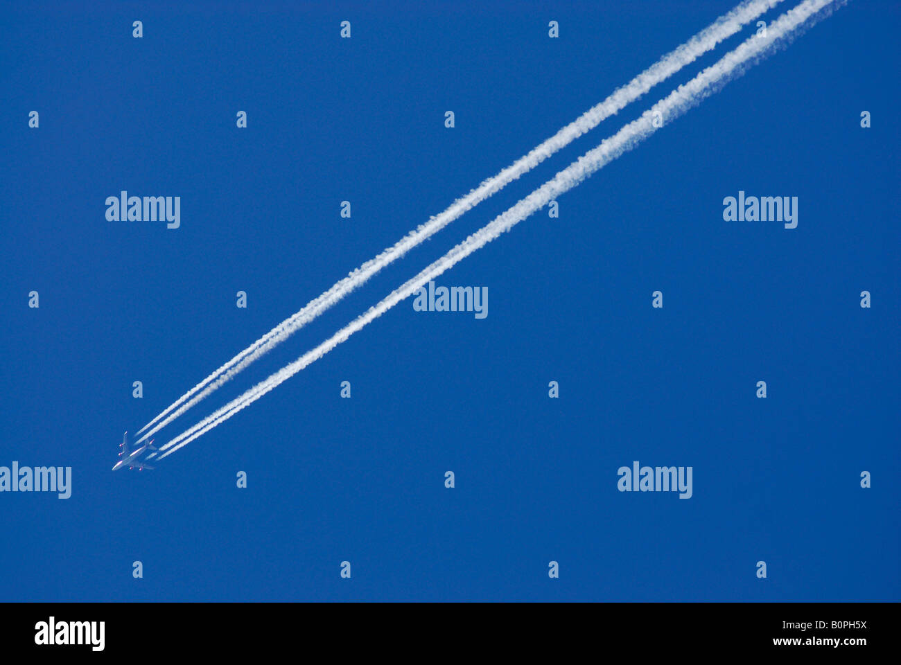 vapor trails or chemtrails from jets in sky often forming grid or ...