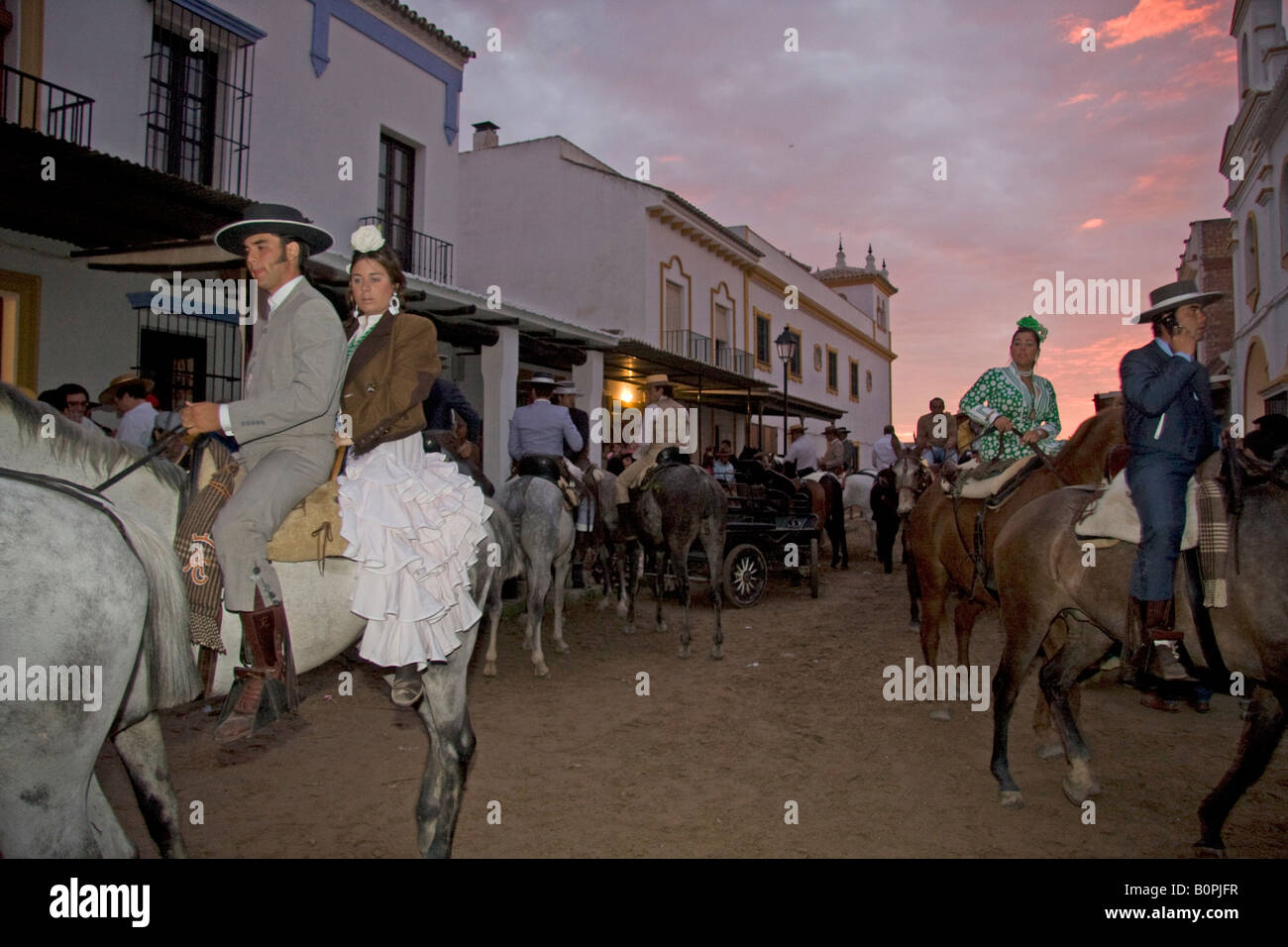 people riding through El Rocío Stock Photo - Alamy