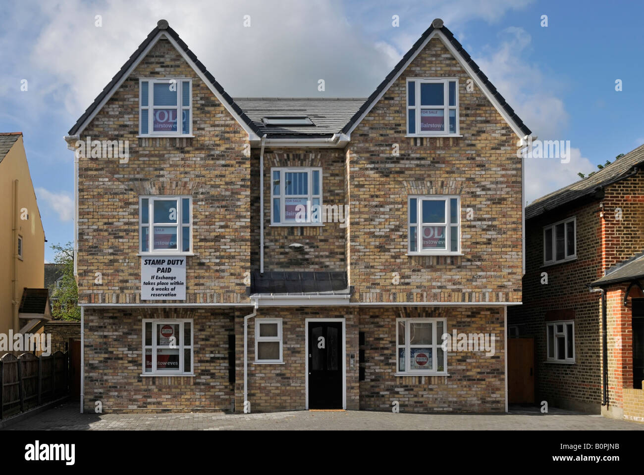 New apartment block with units for sale and notice indicating saving on ...