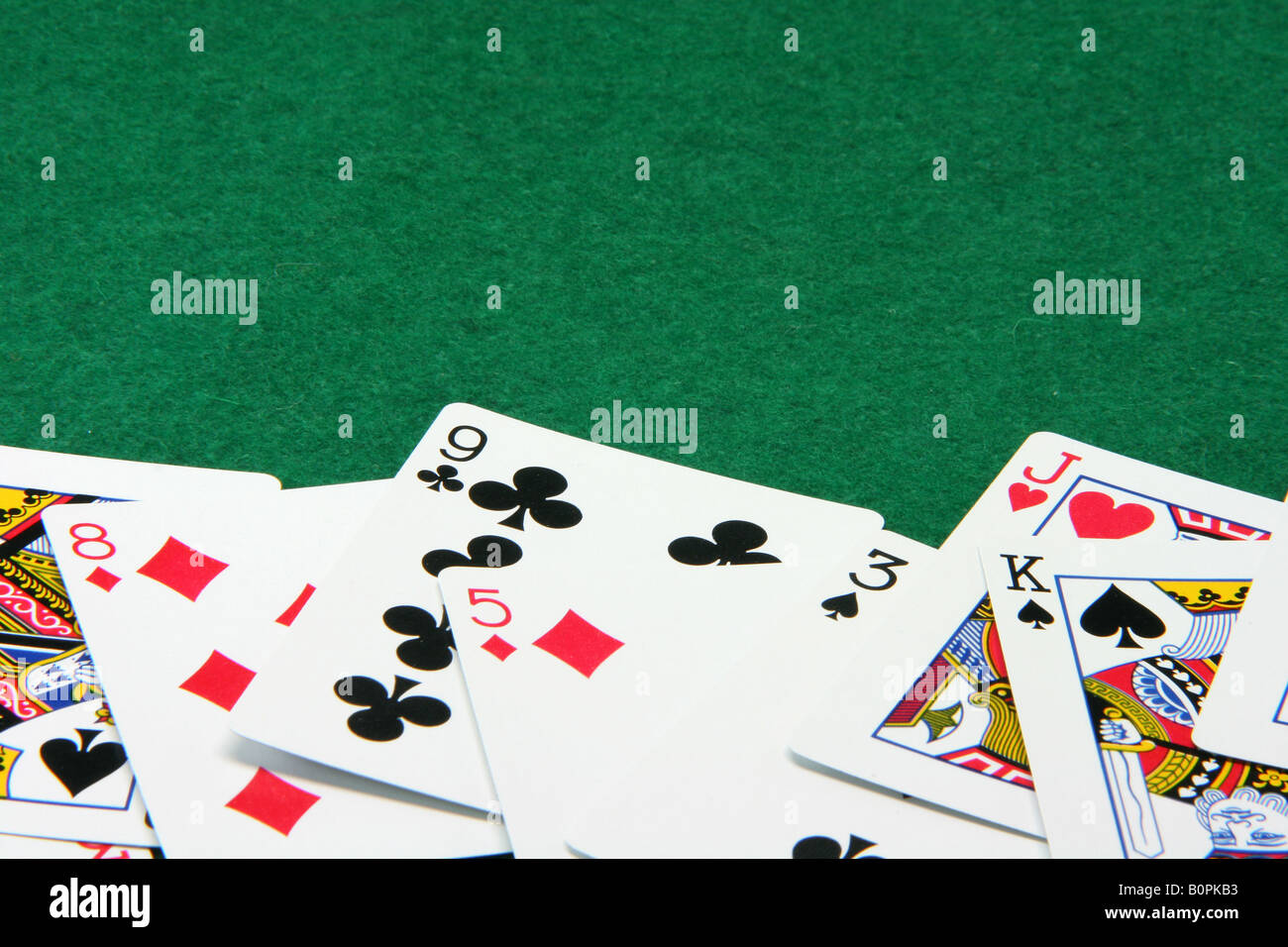 playing cards on green felt with copy space for background use Stock ...