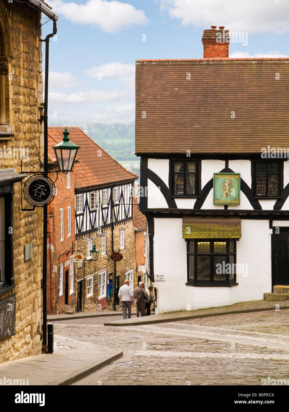 Tourists descending the historic street of Steep Hill in Lincoln ...