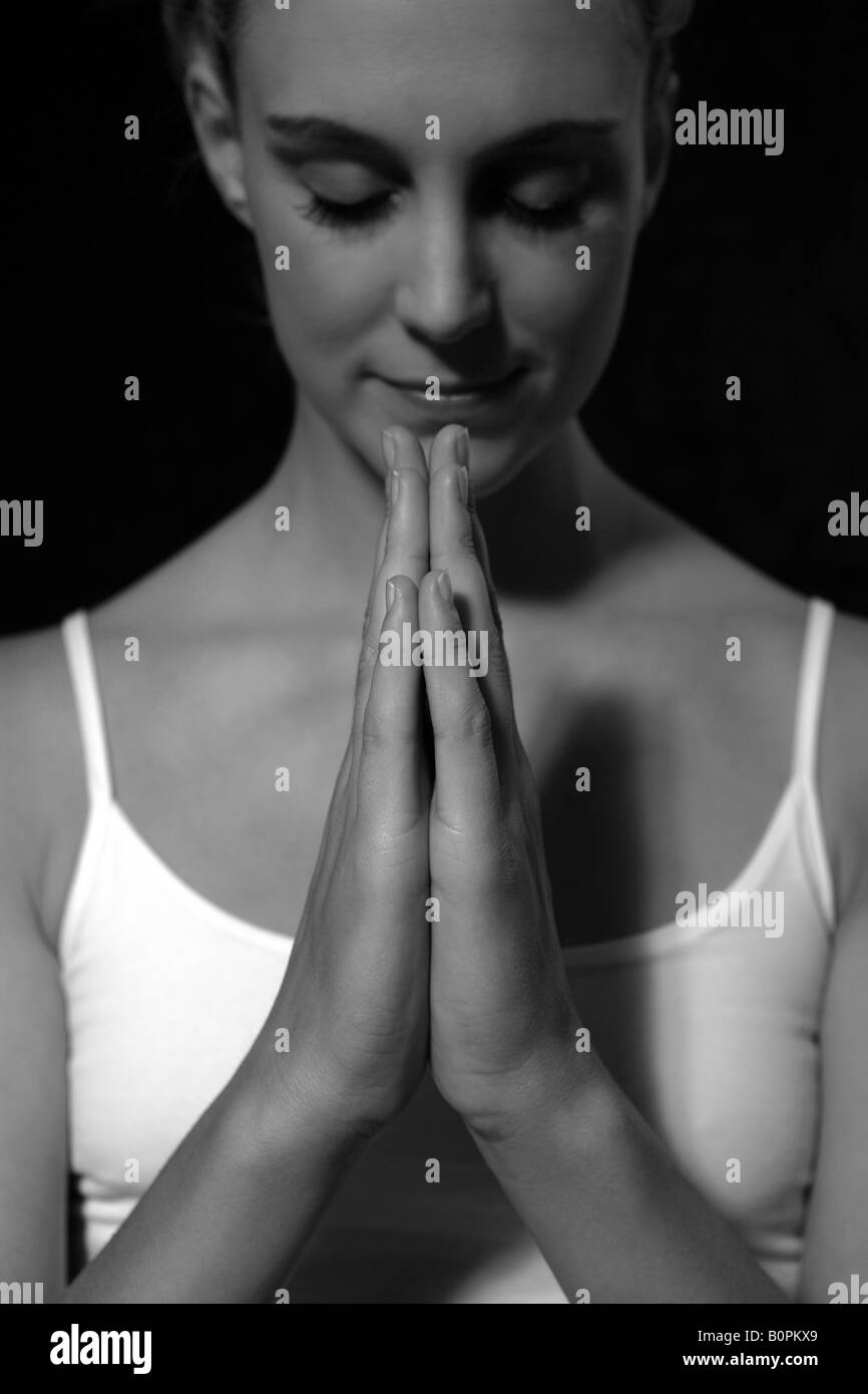 Young woman practices yoga prayer position Stock Photo - Alamy