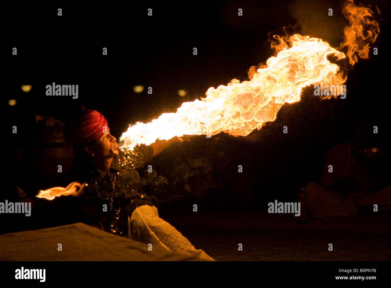 A local gypsy demonstrates fire breathing at a tourist camp near ...