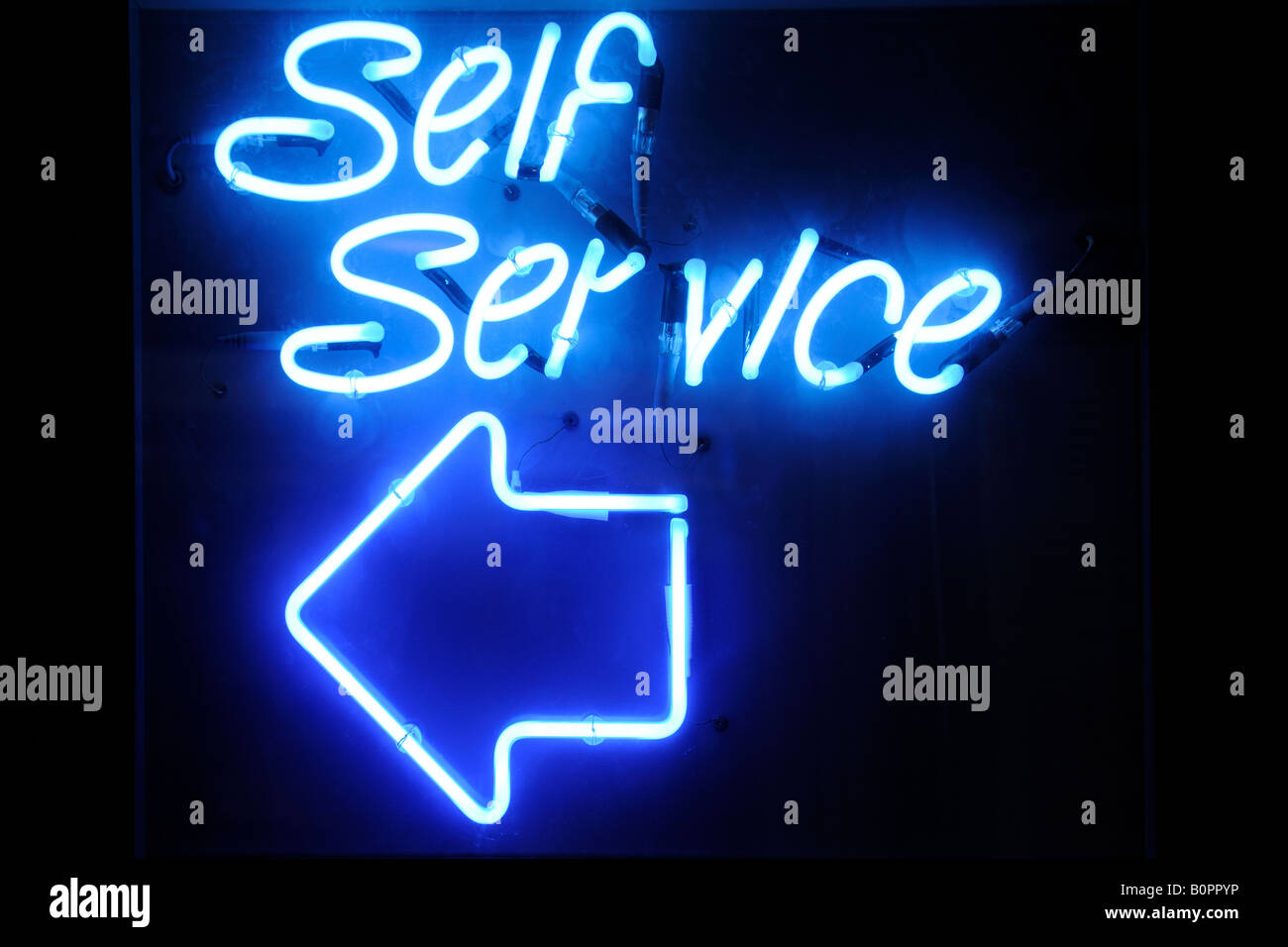 Neon Self Service direction sign Stock Photo - Alamy