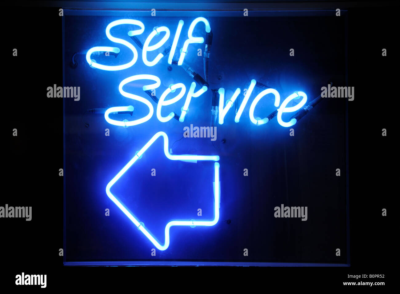 Neon Self Service direction sign Stock Photo - Alamy