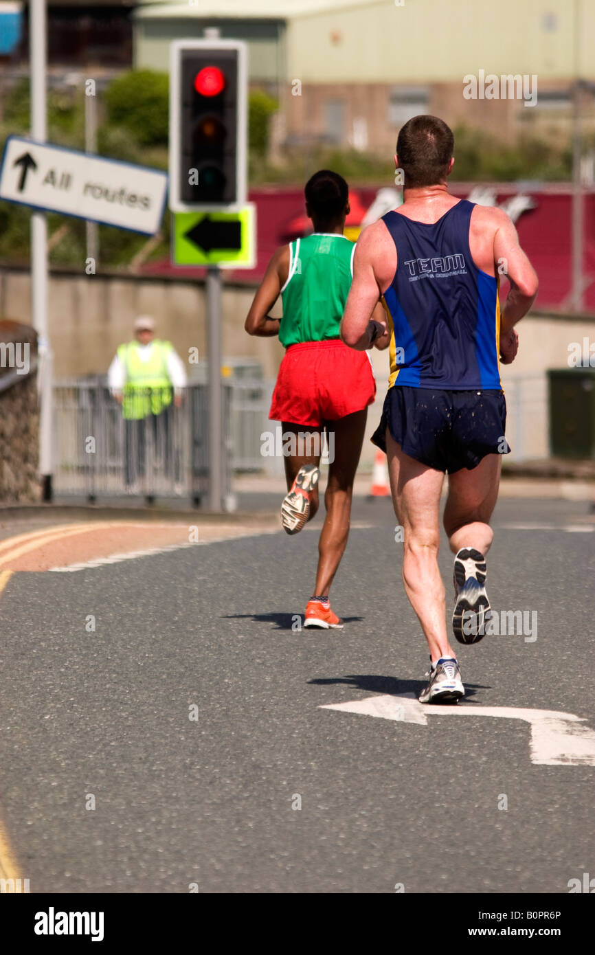Male runner trailing a female runner in Plymouth's Marathon Stock Photo ...