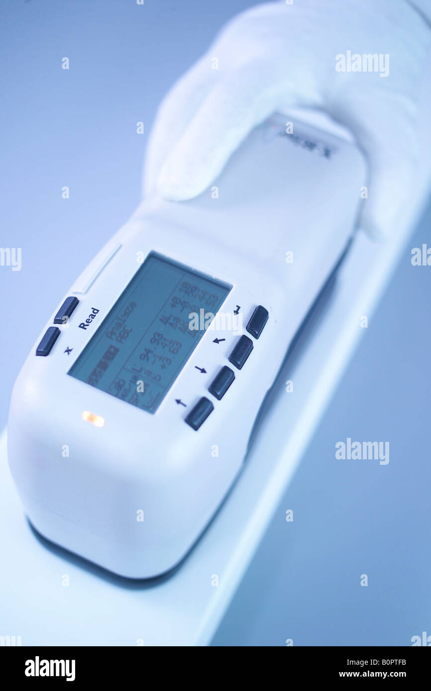 Tester checking the degree of whiteness of plastic Stock Photo - Alamy