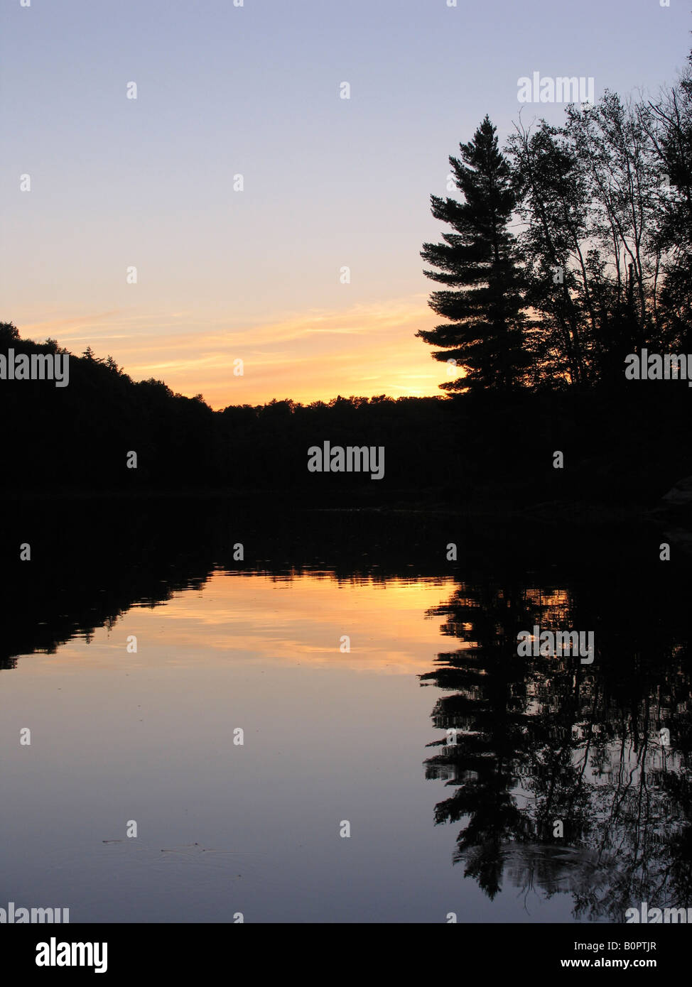 Sunset on a calm northern lake Stock Photo - Alamy