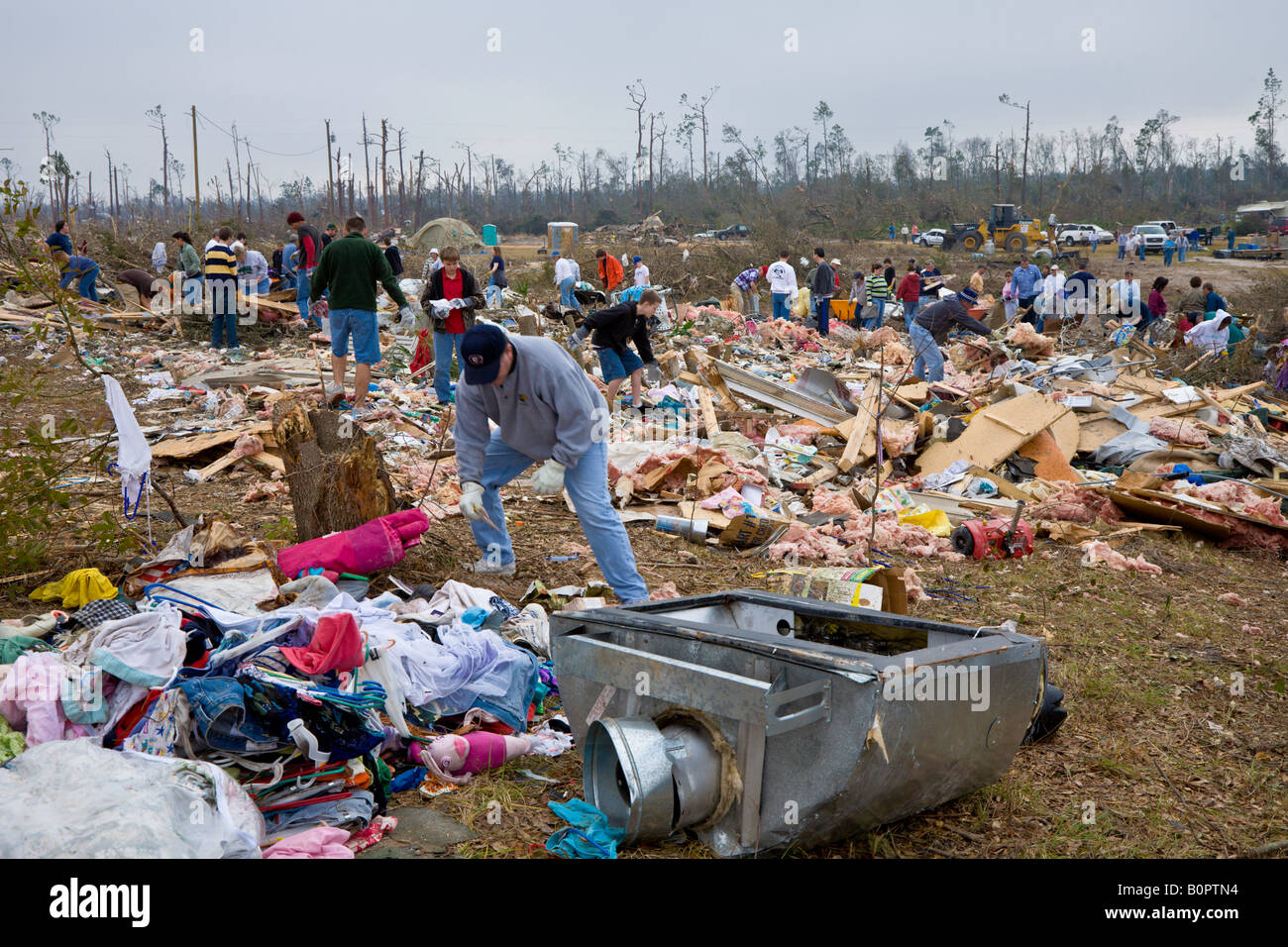 Disaster relief worker picks through destruction to find personal ...