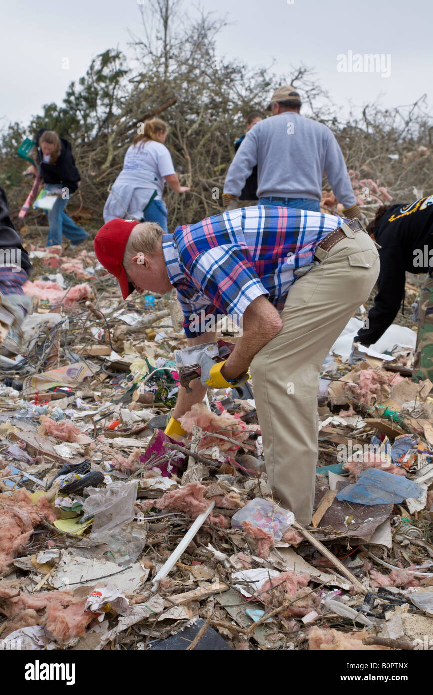Disaster relief worker picks through destruction to find personal ...