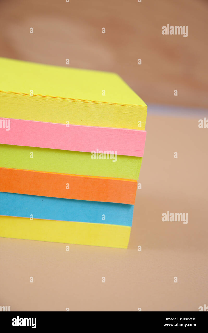 stack of adhesive notepads in a variety of colours on a desk Stock ...