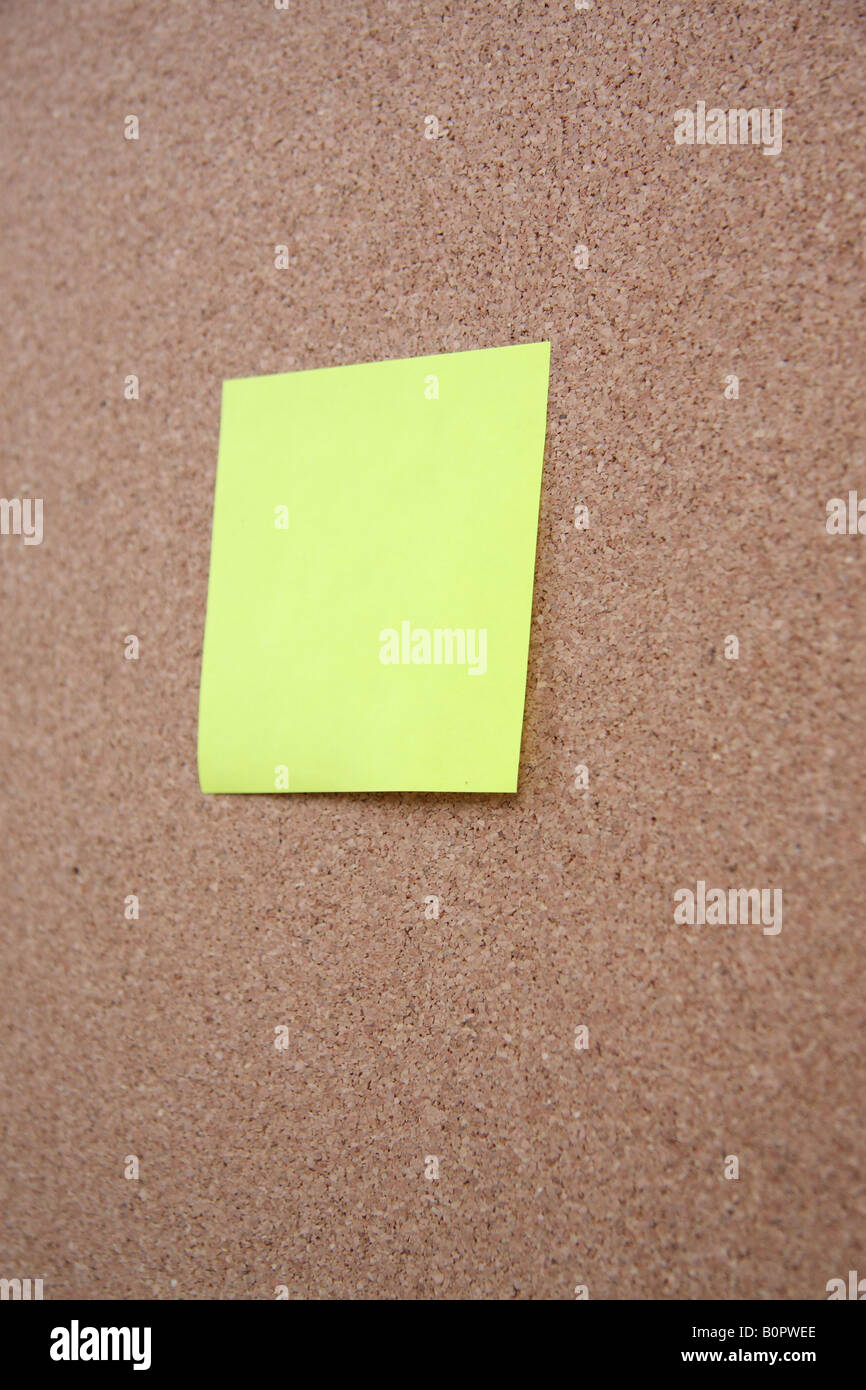 A single adhesive note on a bulletin board Stock Photo - Alamy