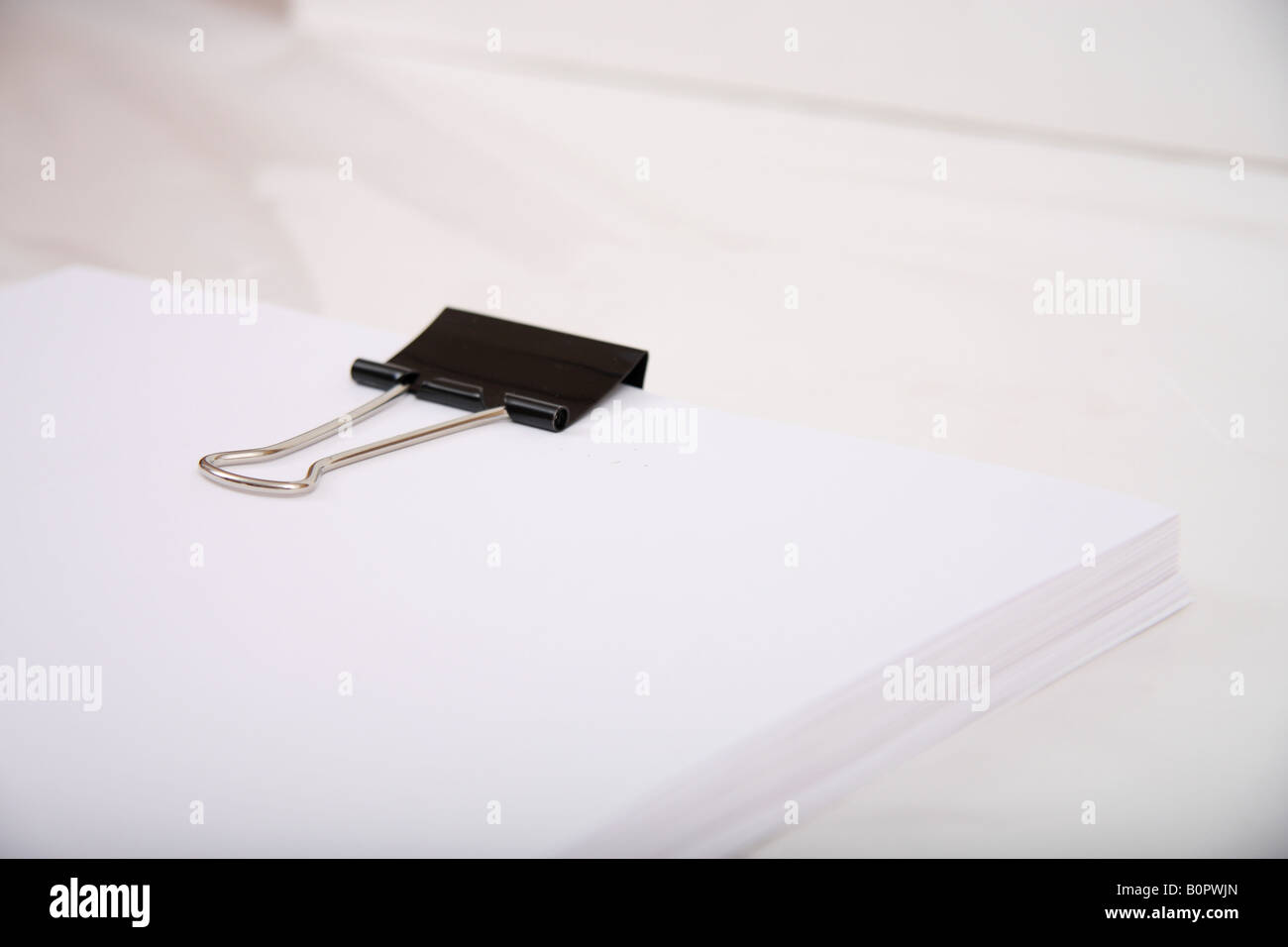 stack of white paper on a desk Stock Photo - Alamy