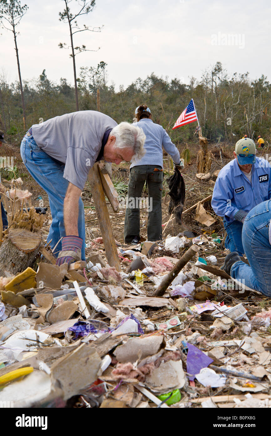 Disaster relief workers pick through destruction to find personal ...