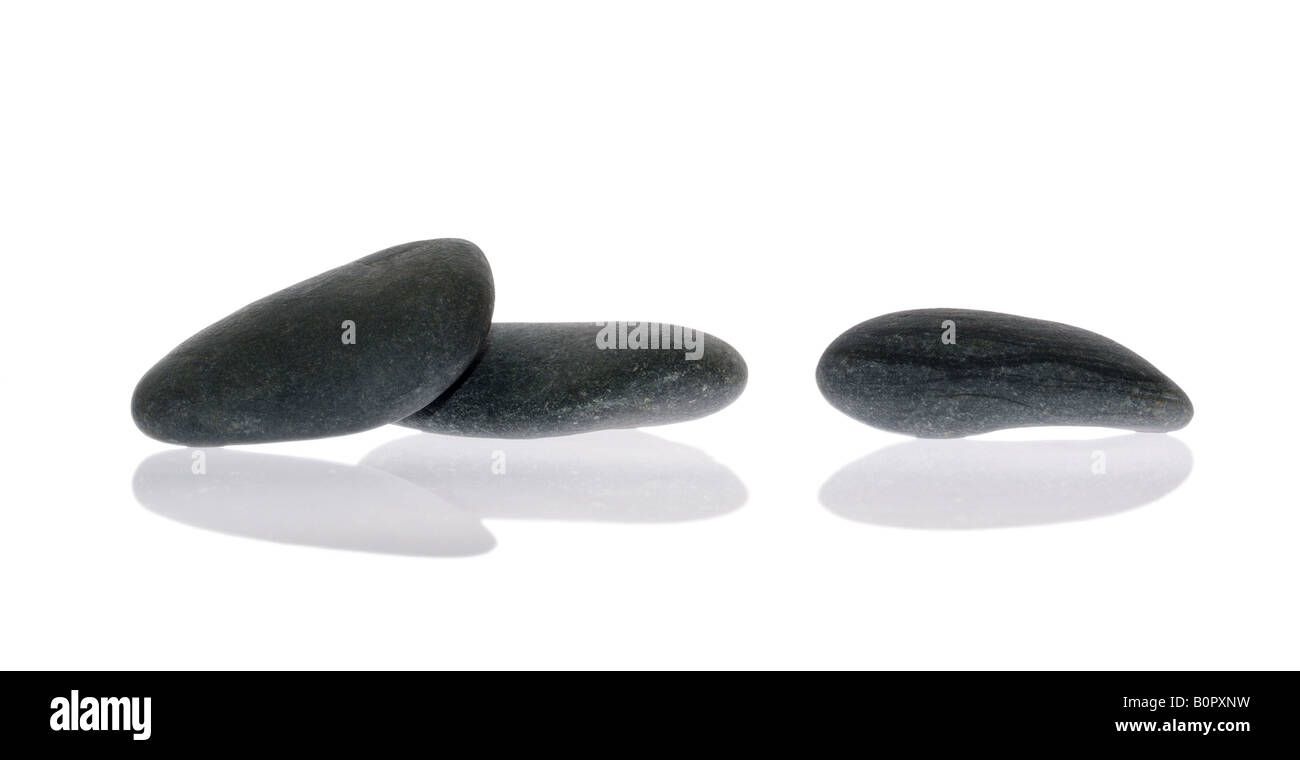 Art of three pieces of black rocks on white background Stock Photo - Alamy