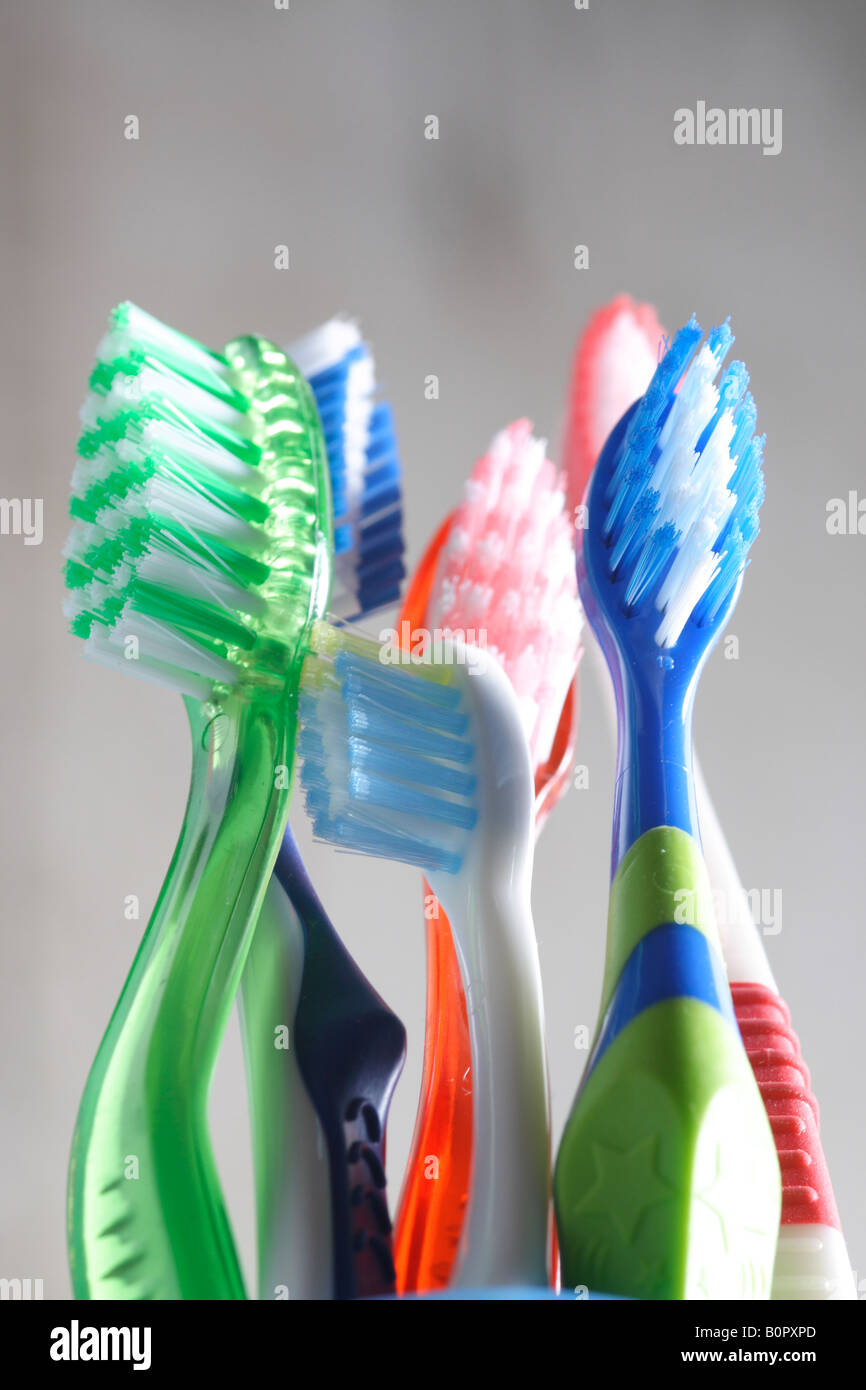 Group of toothbrushes in a cup Stock Photo - Alamy