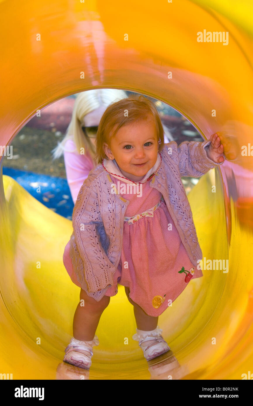 15 month old girl inside a covered slide at a park in Tampa Florida ...