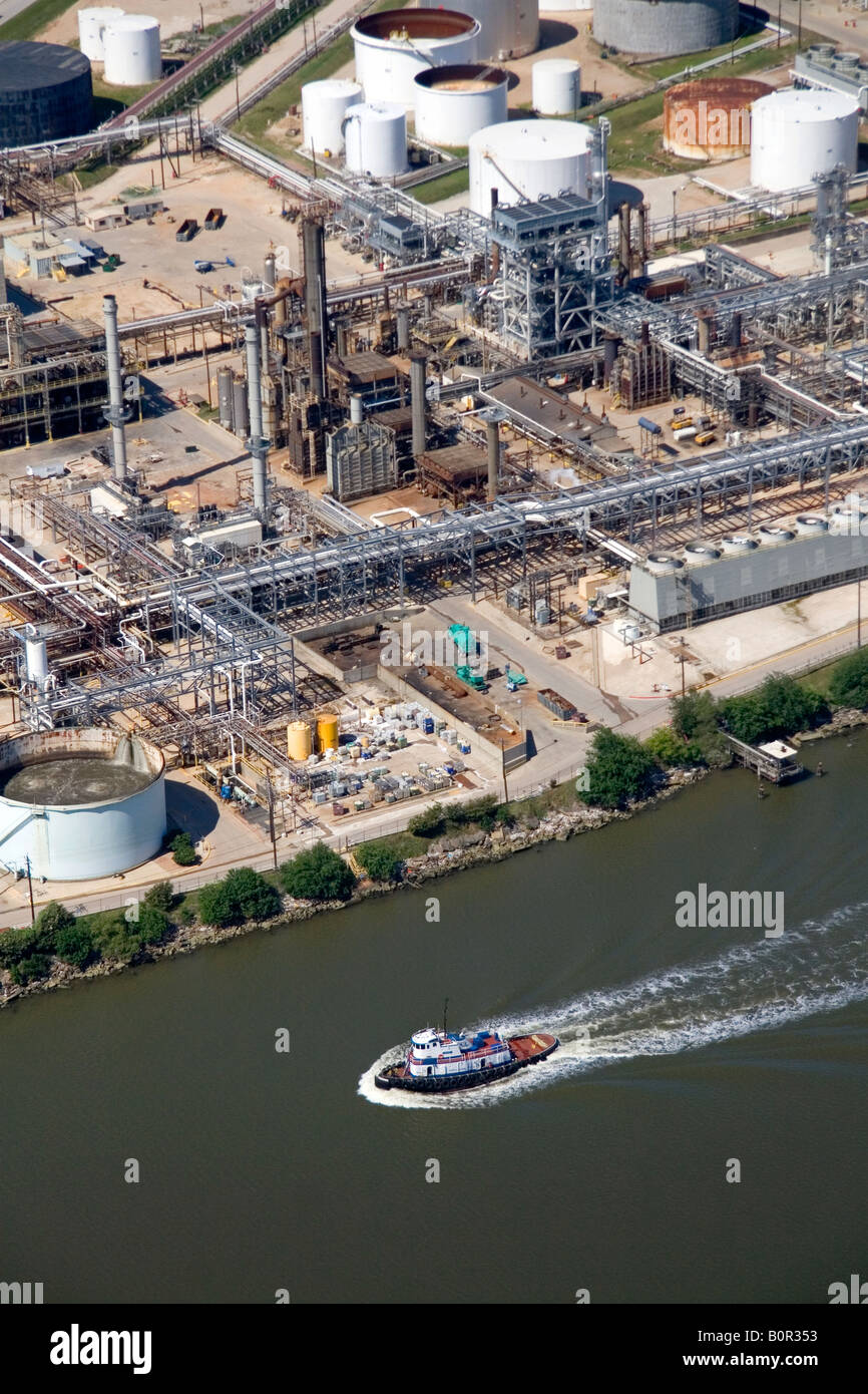 Aerial view of a tugboat on the Houston Ship Channel passing an oil ...