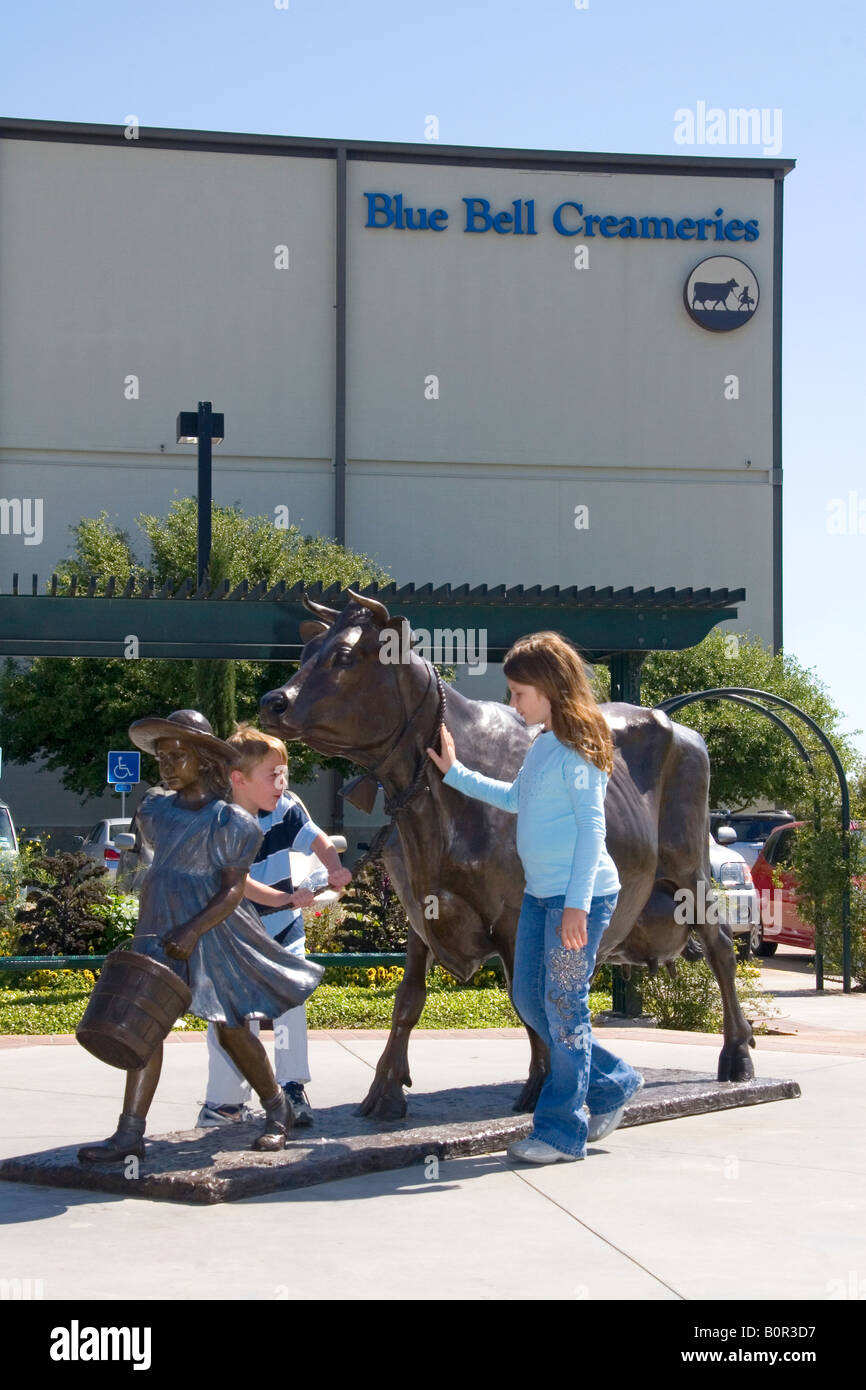 Children play around the Blue Bell Cow and Girl sculpture in front of ...